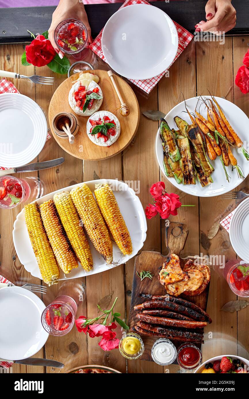 Top view over a dining table, decorated with flowers, with tableware ...