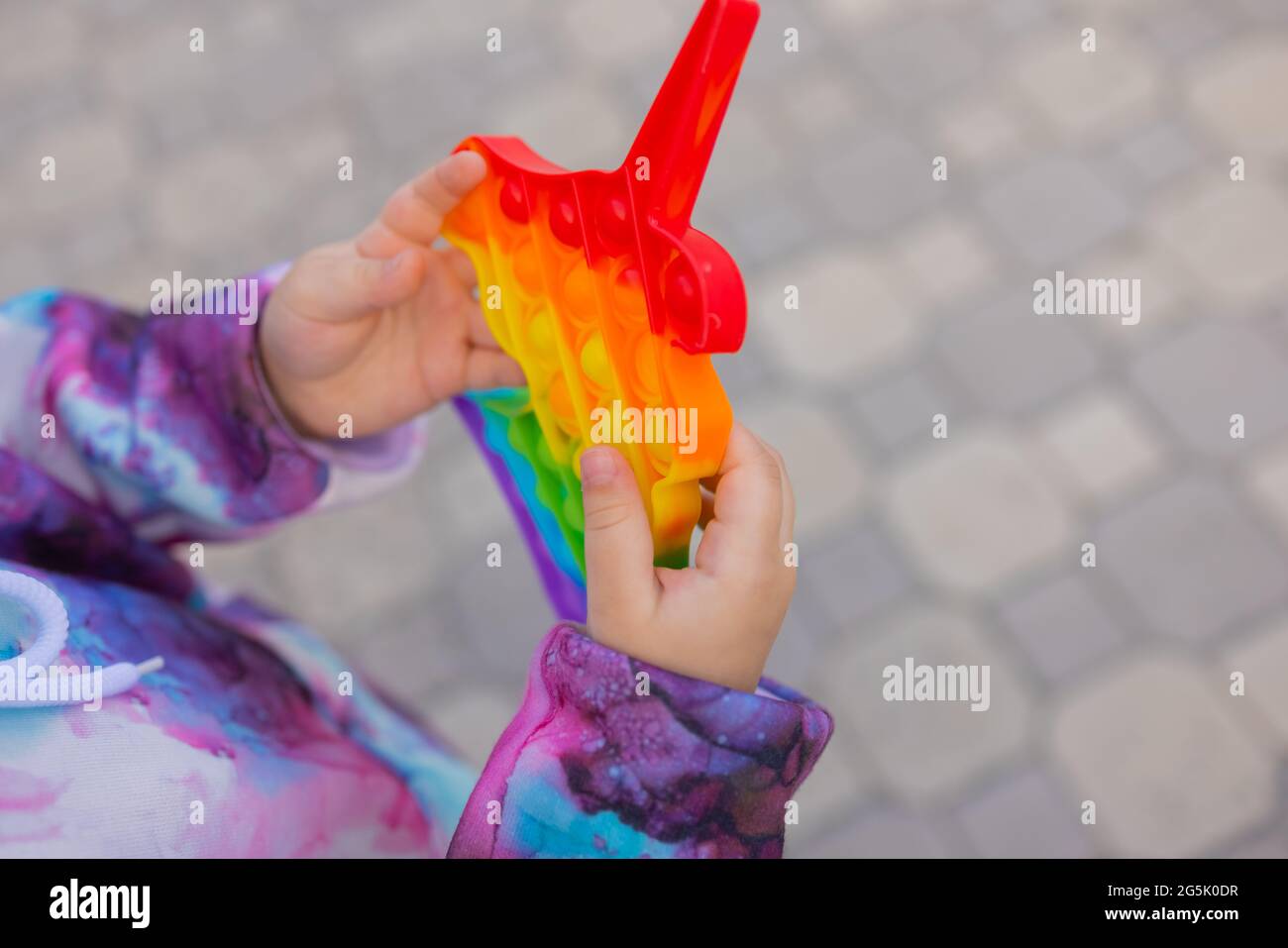 Pop it fidget toy in girl hand's. Colorful antistress kid's toy fidget ...