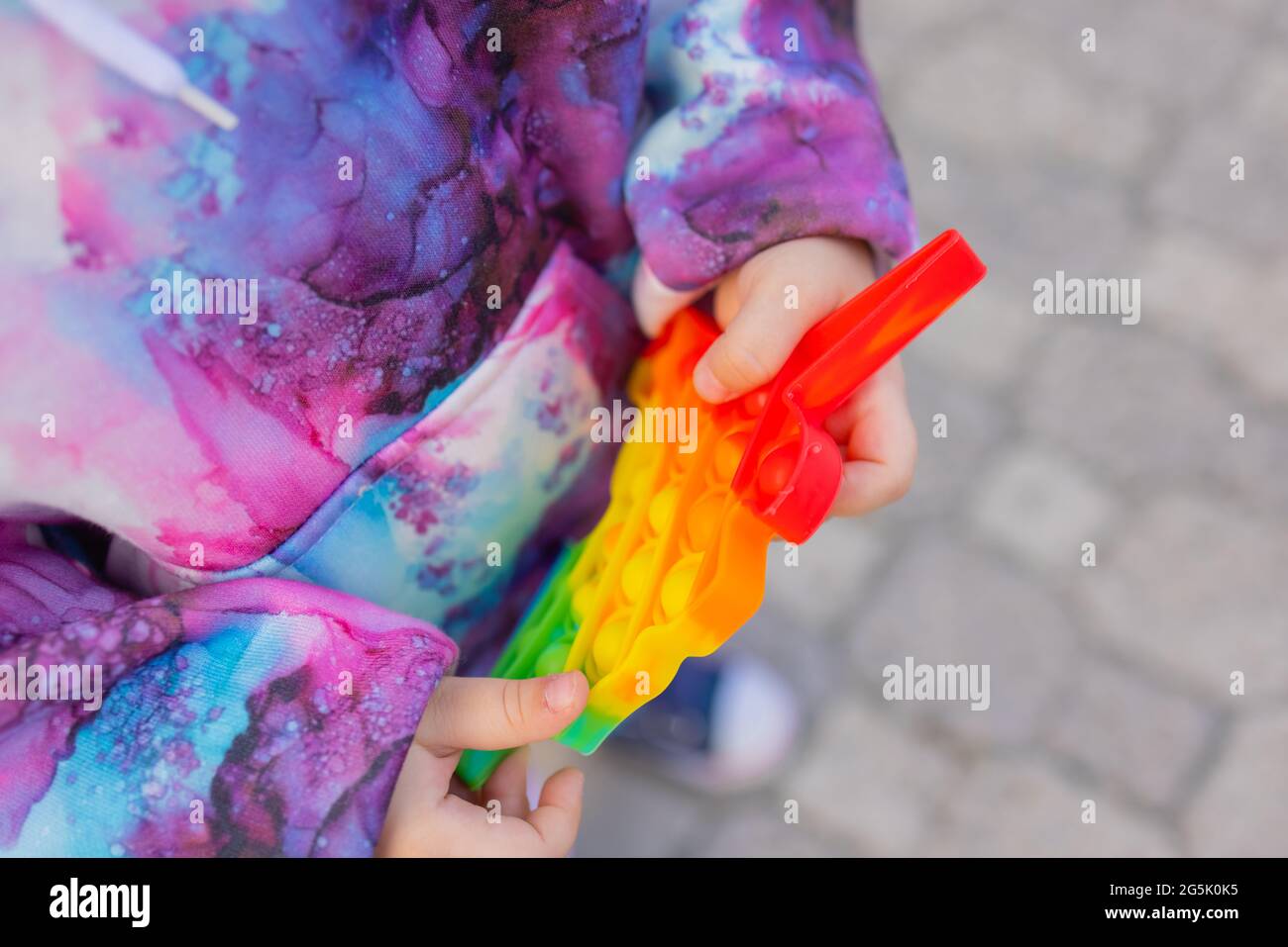 Pop it fidget toy in girl hand's. Colorful antistress kid's toy fidget ...