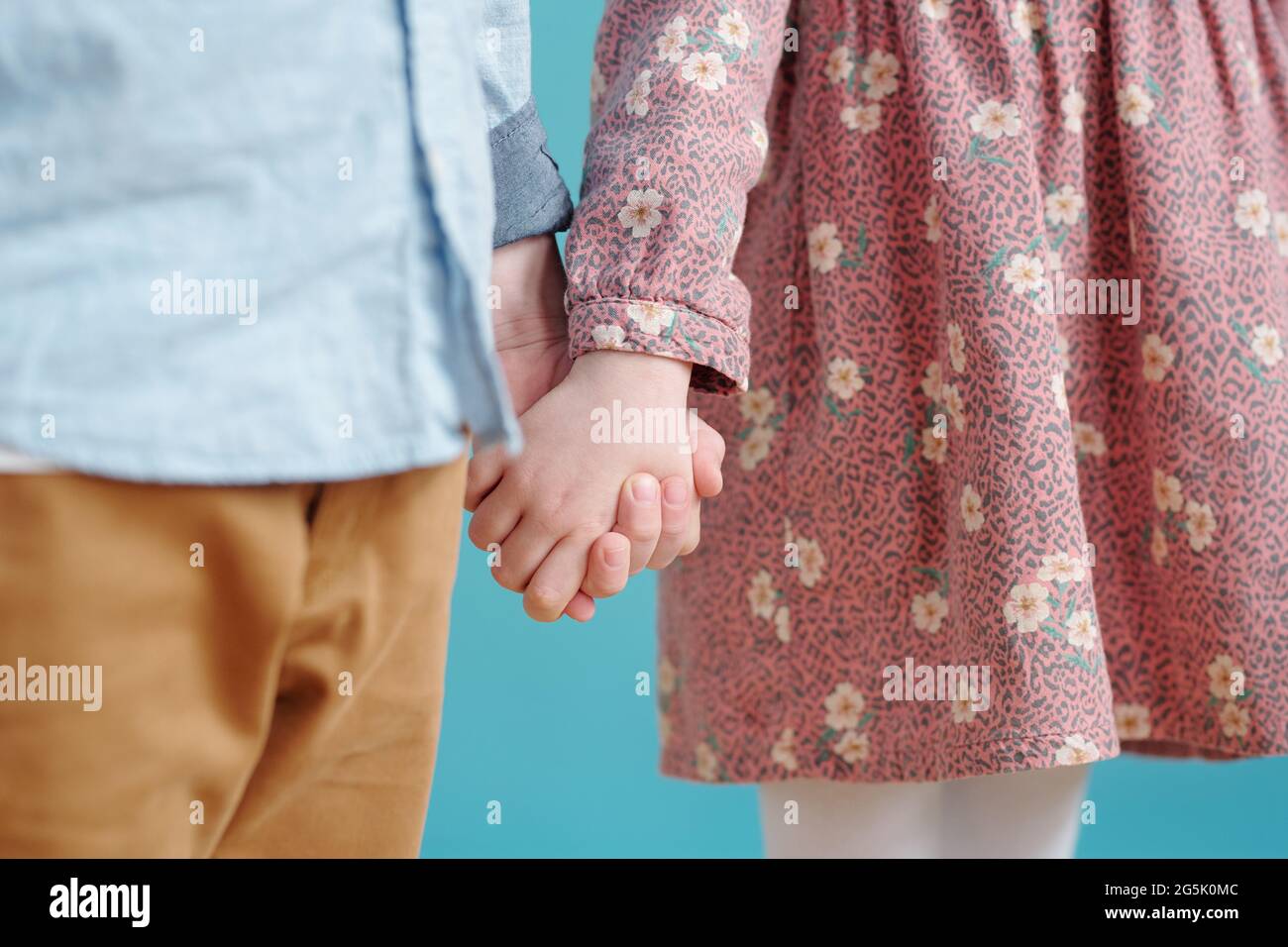Two children holding hands school hi-res stock photography and images ...