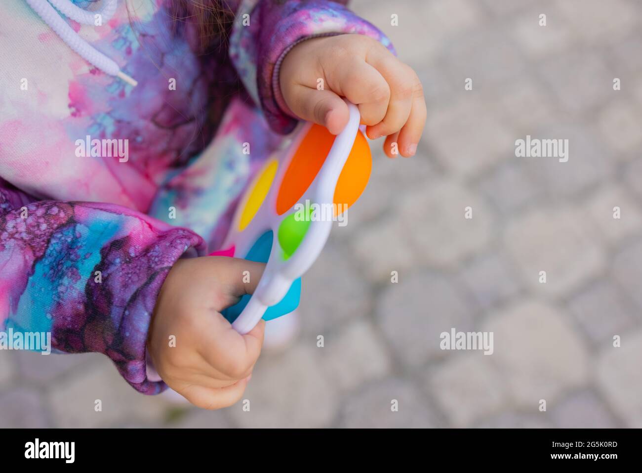 Pop it fidget toy in girl hand's. Colorful antistress kid's toy fidget ...