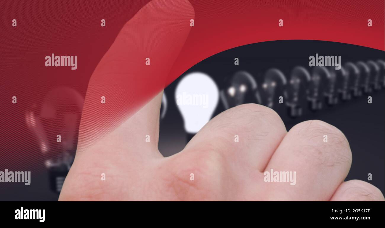 Composition of finger touching lit light bulb with row of light bulbs ...