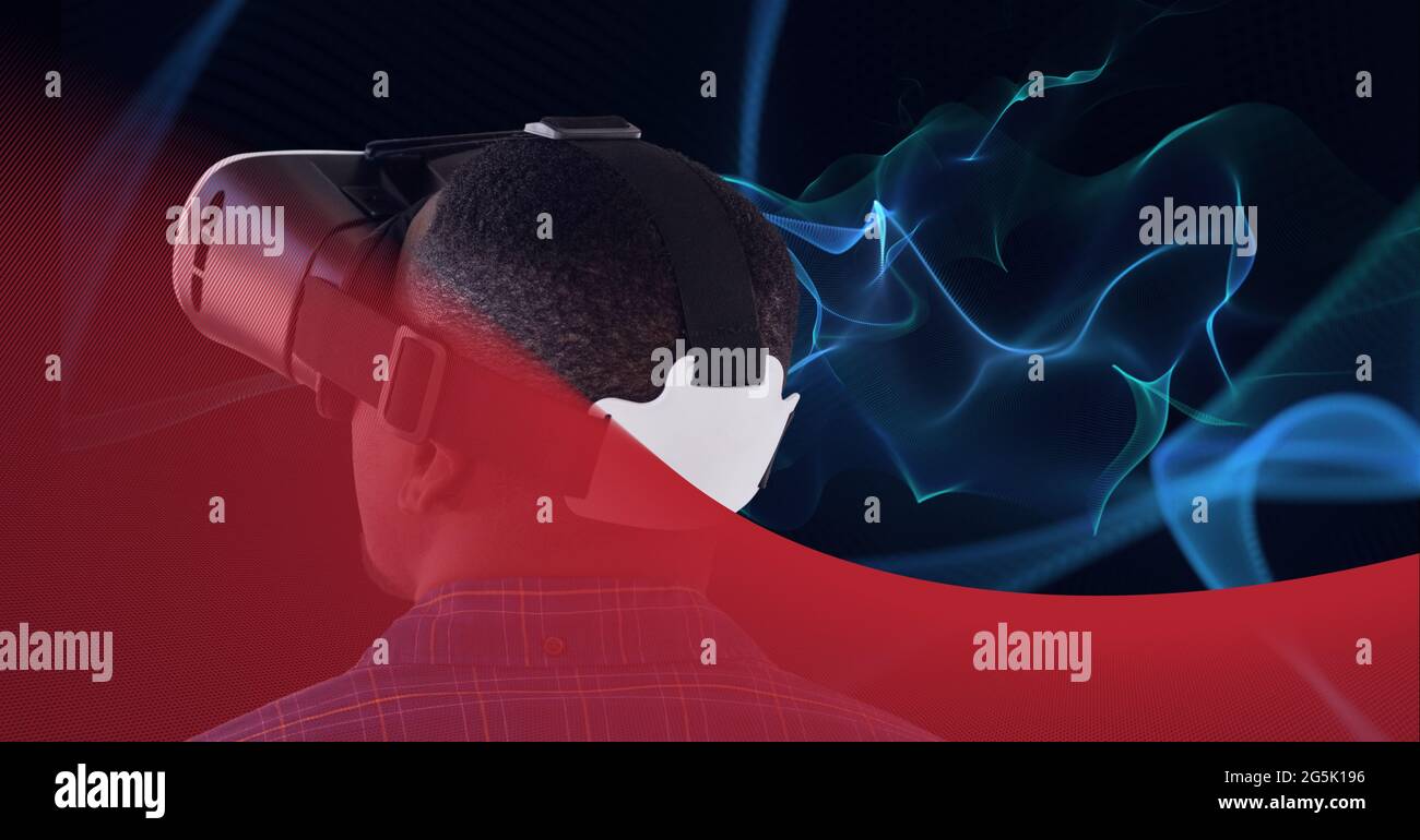 Composition of blue light trails and man wearing vr headset touching ...