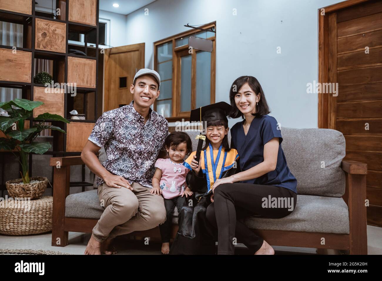 Happy asian family graduate at home. elementary school student at home ...