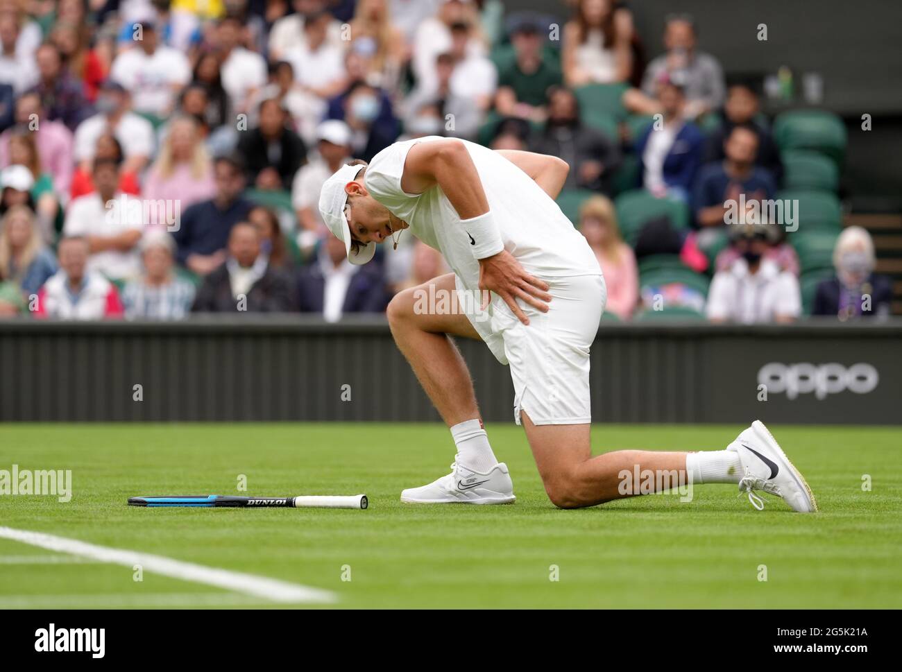 Jack Draper gets up after stumbling in the match against Novak Djokovic ...