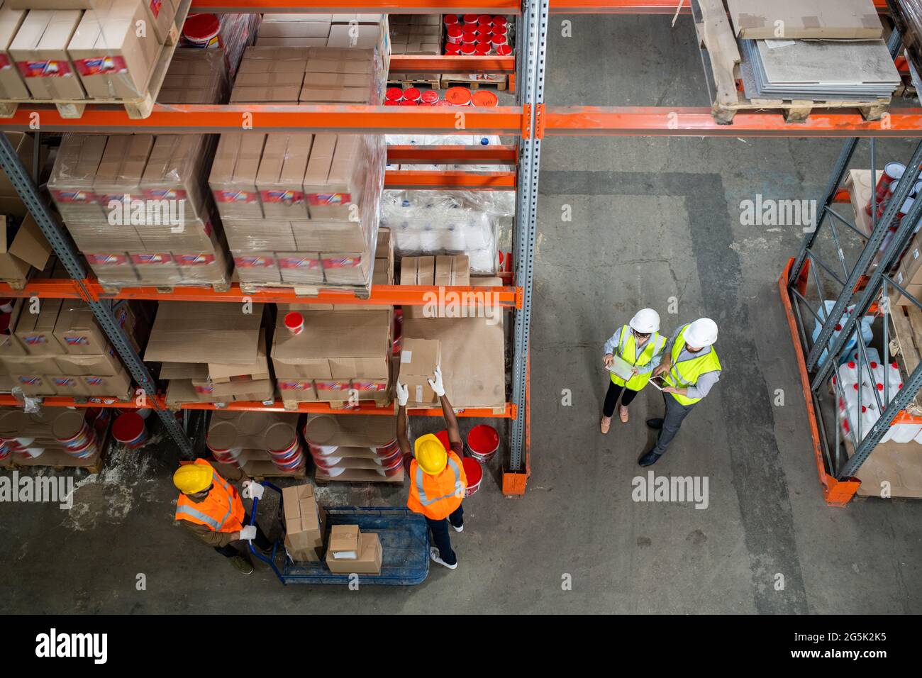 Two groups of employees working in large contemporary warehouse Stock ...