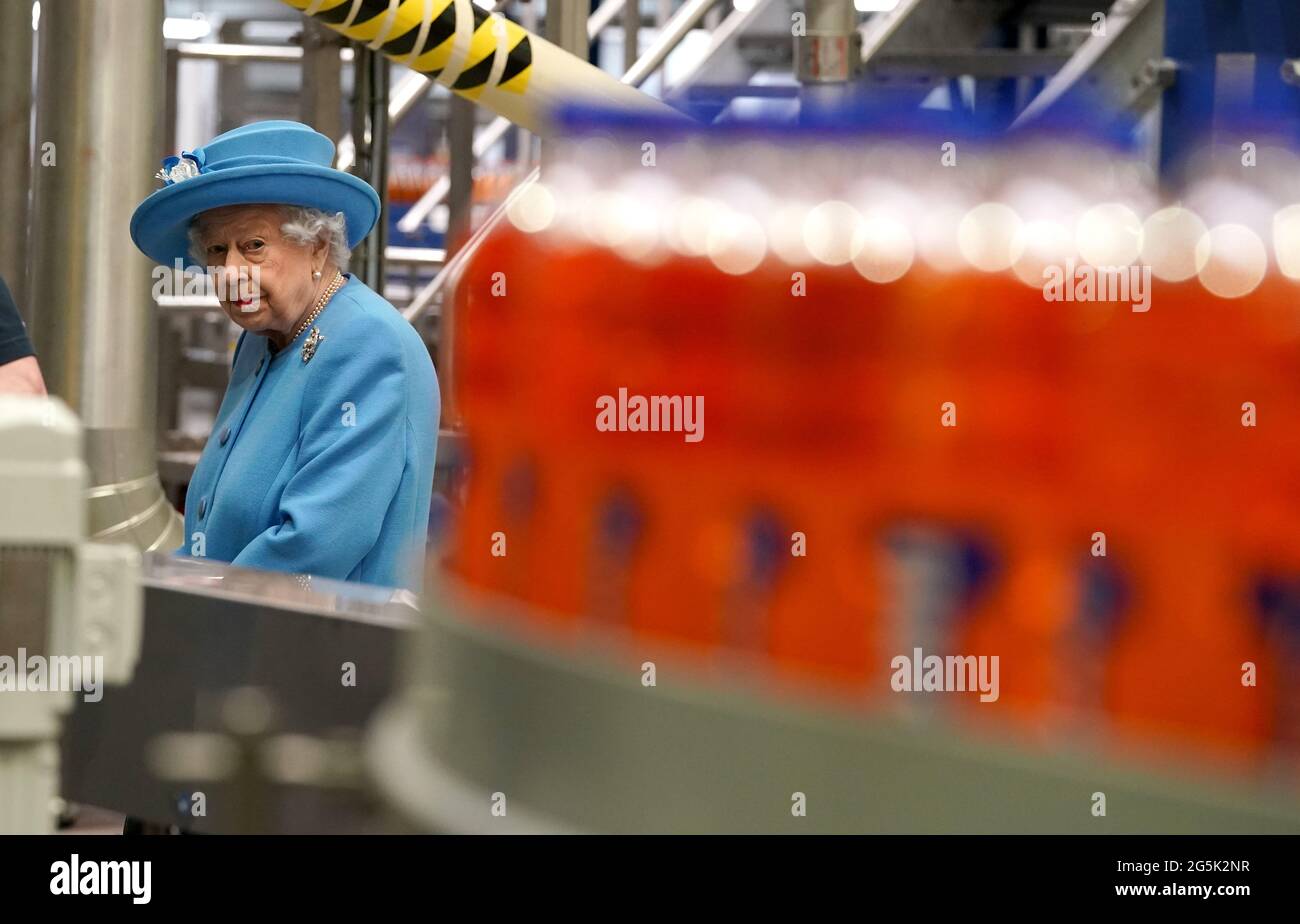 Queen Elizabeth II walks through the factory floor during a visit to AG ...