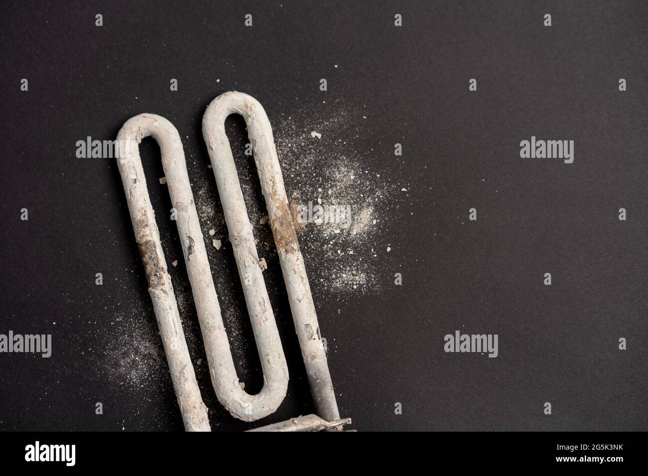 Damaged heating element of washing machine with scum and sediment on ...