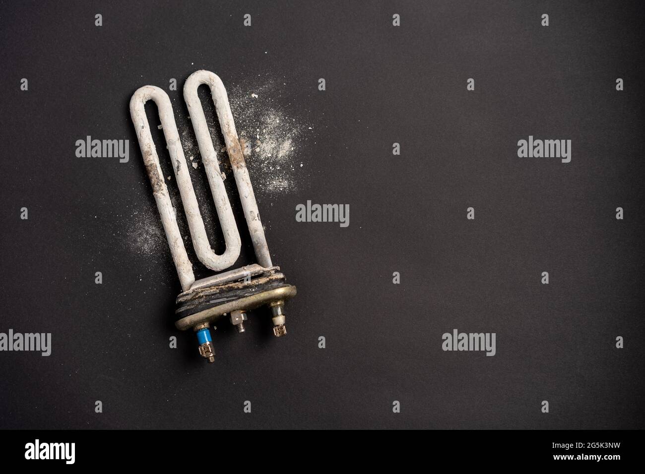 Damaged heating element of washing machine with scum and sediment on ...