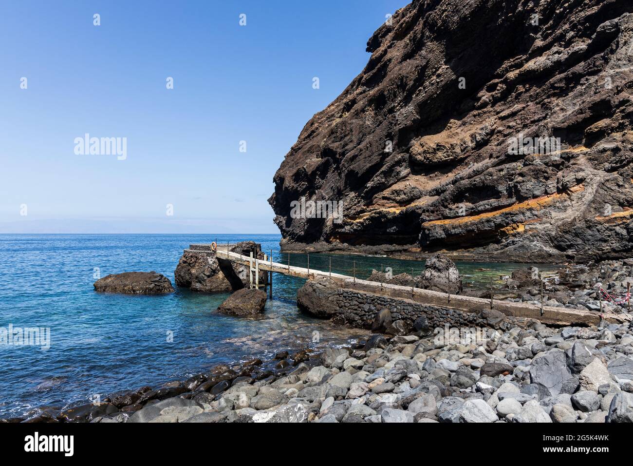 Dock on the coast at the bottom of the Barranco of Masca, volcanic ...