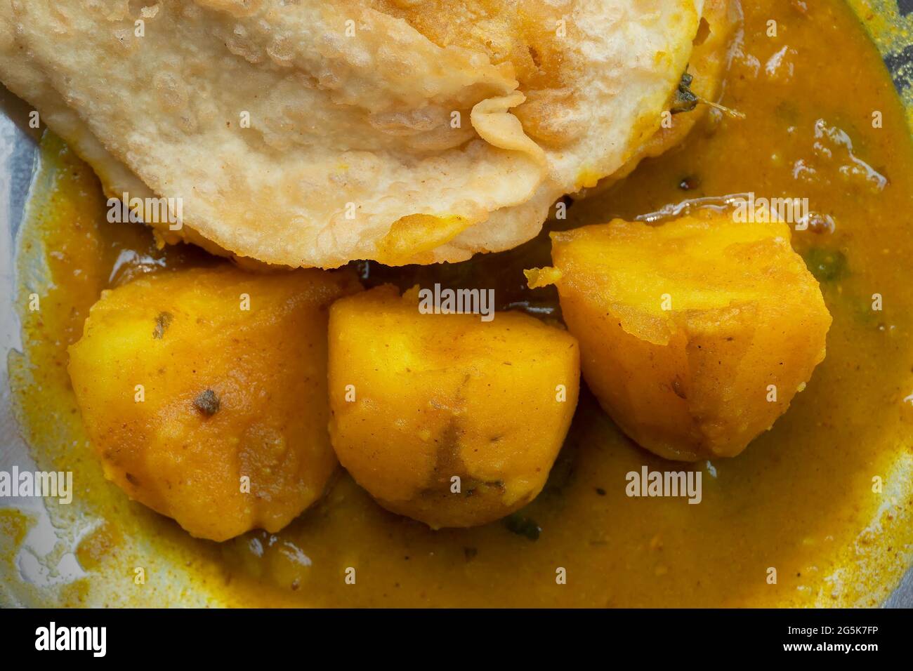 Top view of kachori with alur dom, a famous Bengali dish. Kochuri ...