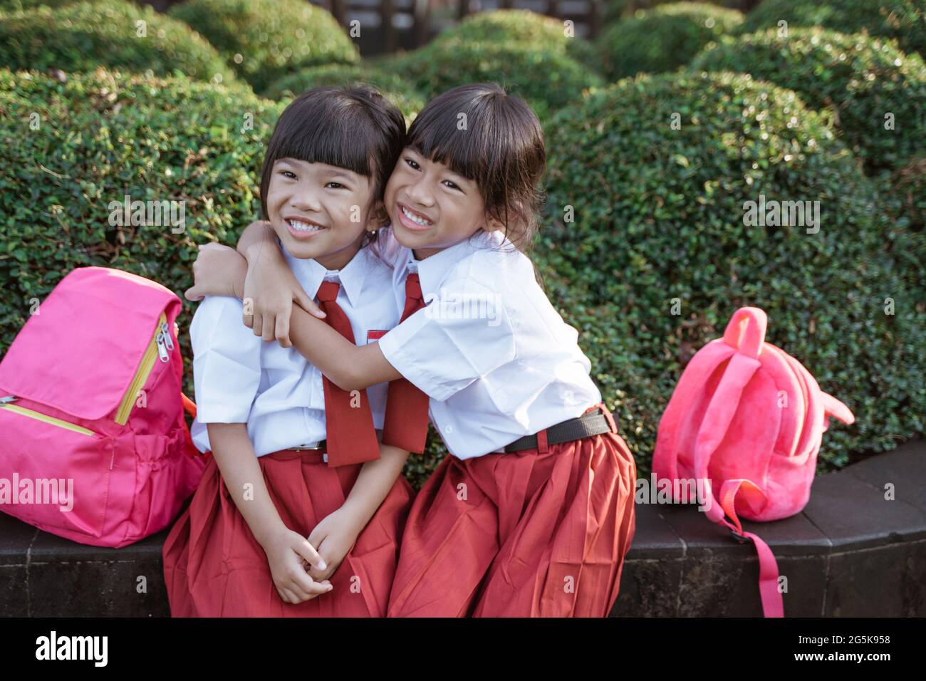 happy student friend in uniform smiling Stock Photo - Alamy