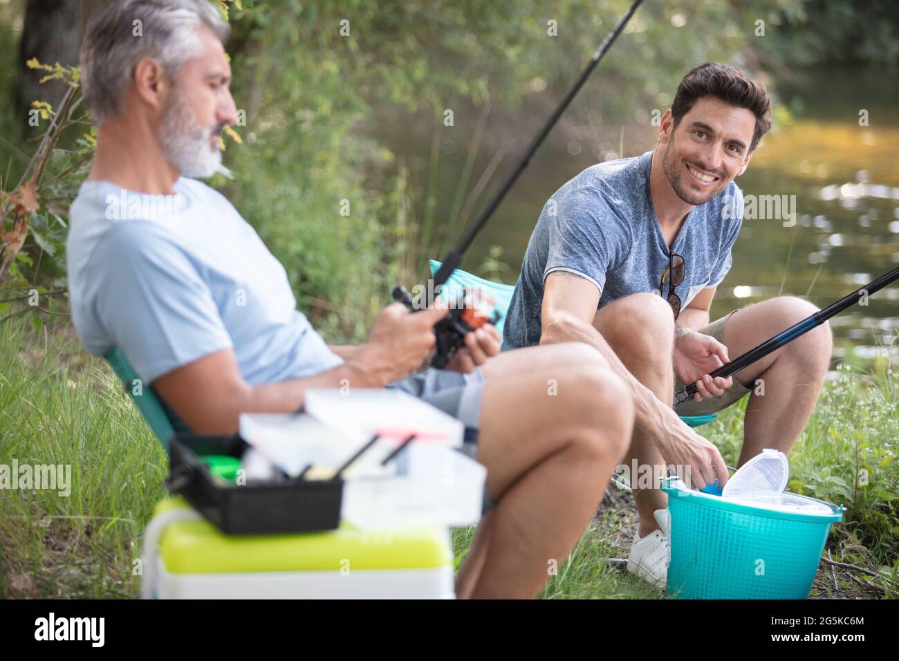 two male friends fishing together Stock Photo - Alamy
