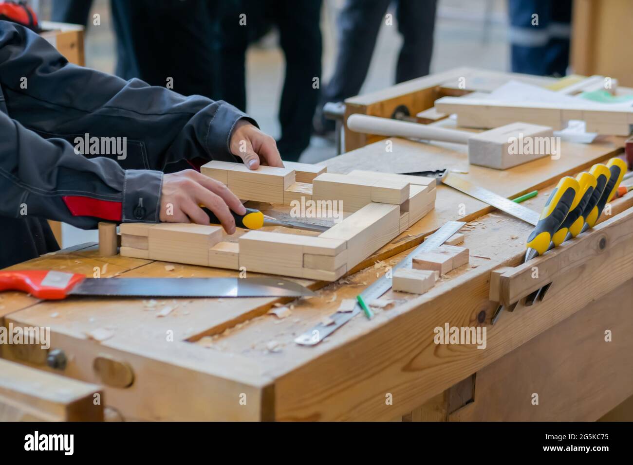 Professional man carpenter working with wooden detail - assembling ...