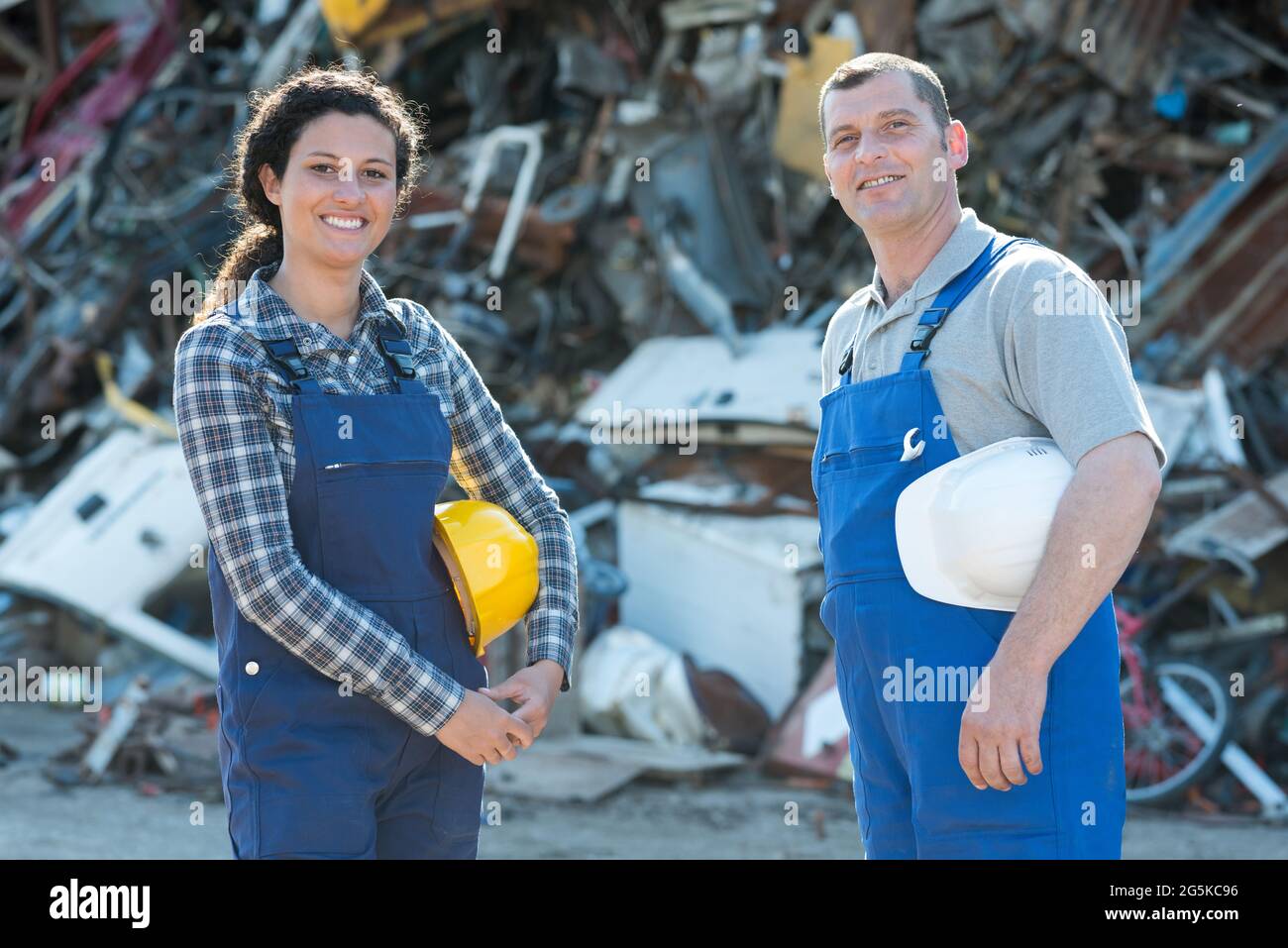 female and male junkyard worker looking at camera Stock Photo - Alamy