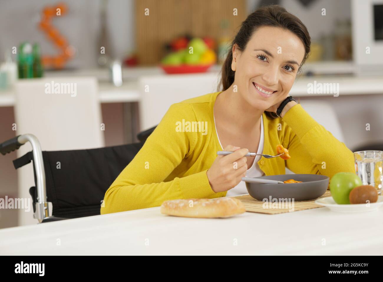 happy disable woman eating pasta Stock Photo - Alamy