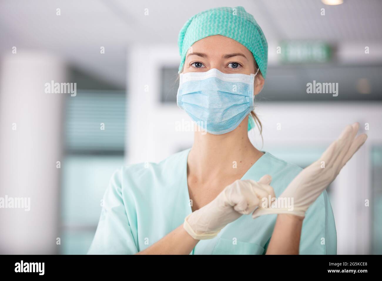 female surgeon in uniform getting ready for medical procedure surgery ...