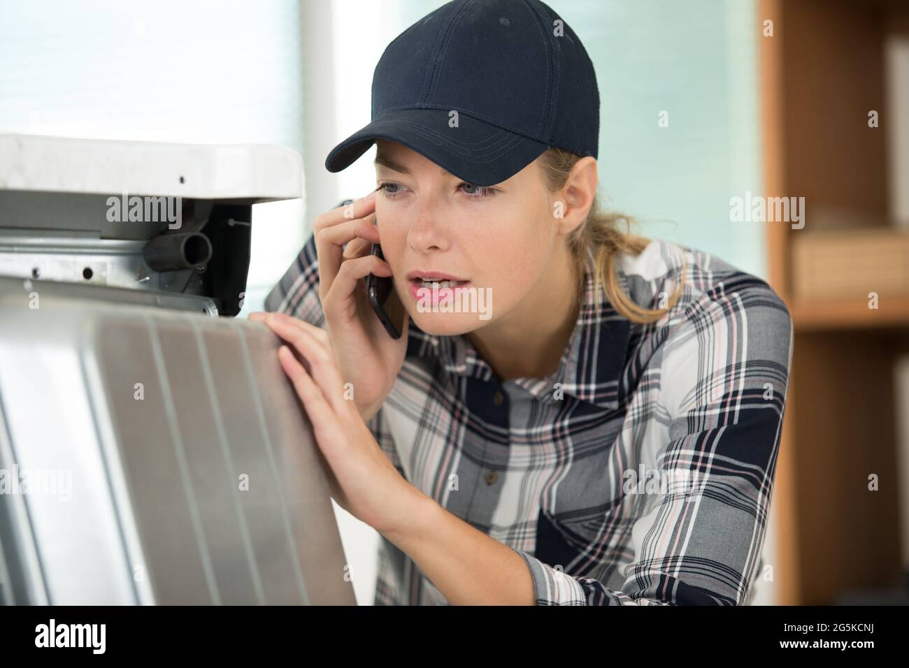young plumber woman happy talking using a smartphone mobile phone Stock ...