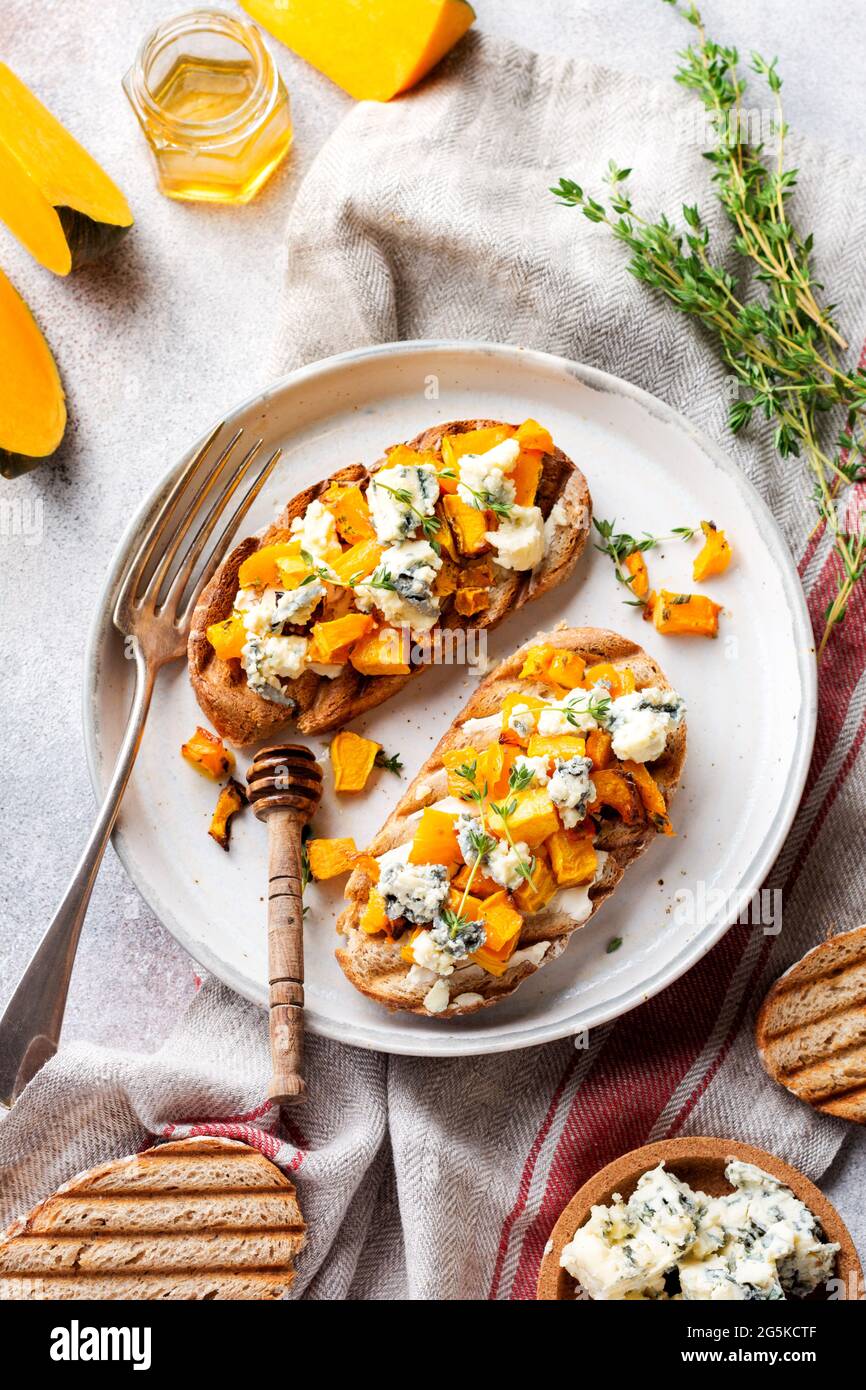 Sandwich with baked pumpkin and dorblu cheese with blue mold, honey and ...