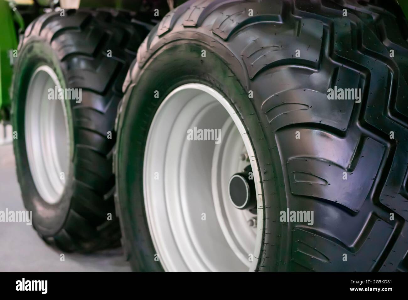 Close up view of two heavy tractor tires and wheels at farming ...