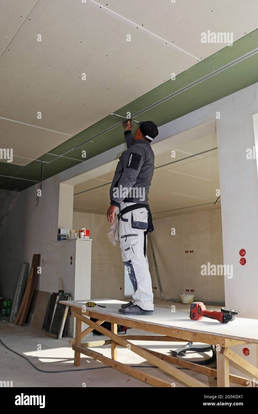 Man working on drywall construction Stock Photo - Alamy