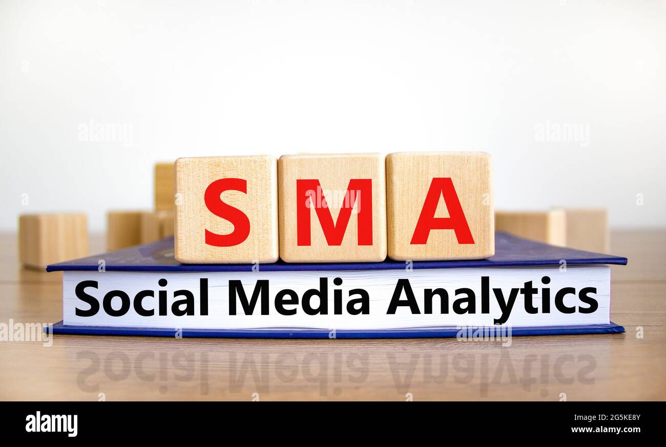 SMA social media analytics symbol. Wooden cubes on book with word 'SMA ...
