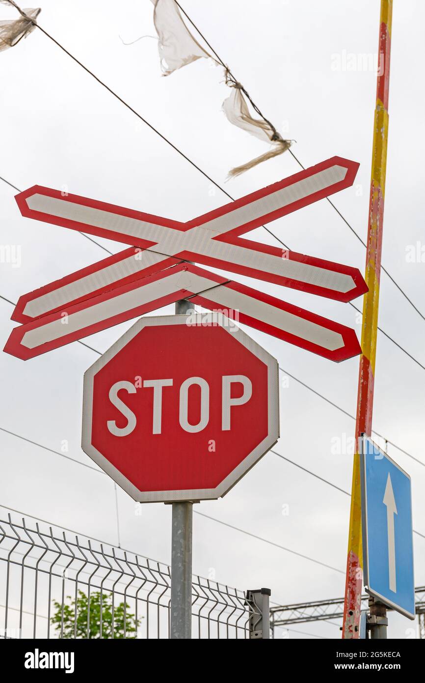 Stop Sign at Multi Rails Crossing Intersection Stock Photo - Alamy