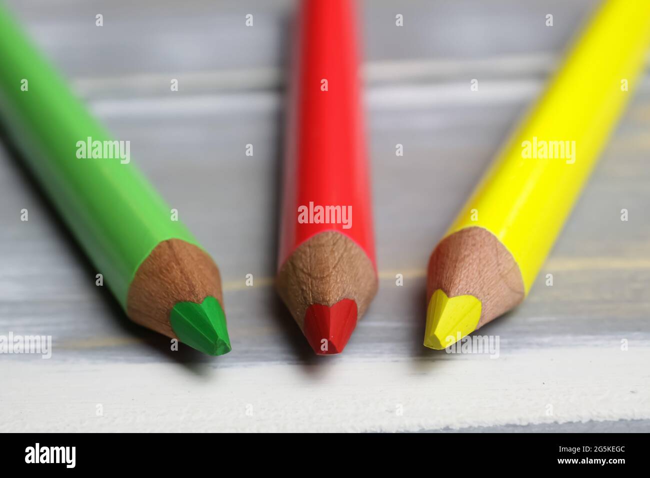 Closeup of isolated colorful yellow, red, green crayons on wood ...