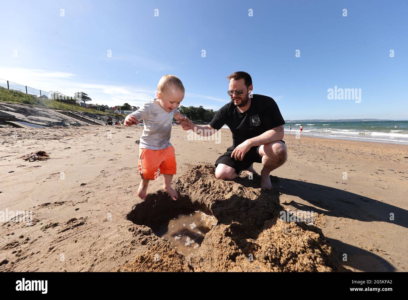 Connaloch Reilly, 2, with his father Donal Reilly playing in the sand ...