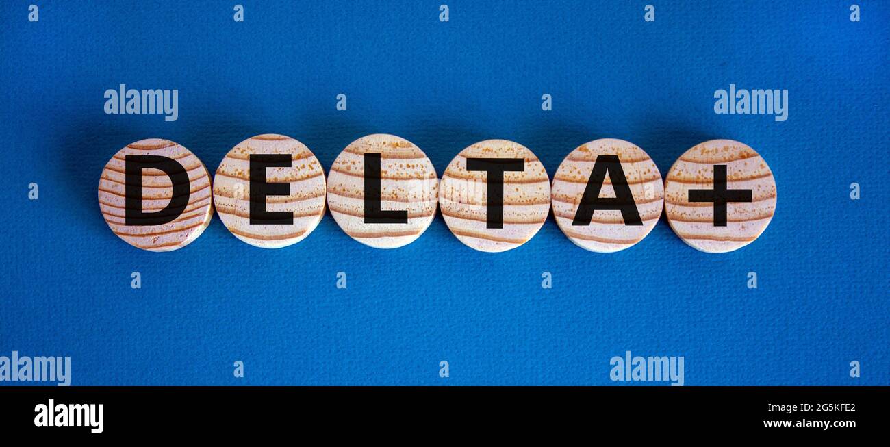 Covid-19 delta plus variant symbol. Wooden circles with words Delta ...