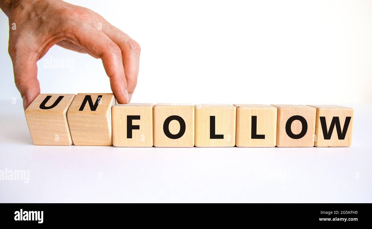 Follow or unfollow symbol. Businessman turns wooden cubes and changes ...