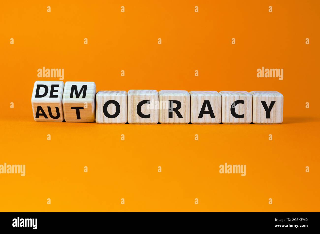 Democracy or autocracy symbol. Turned wooden cubes and changed the word ...