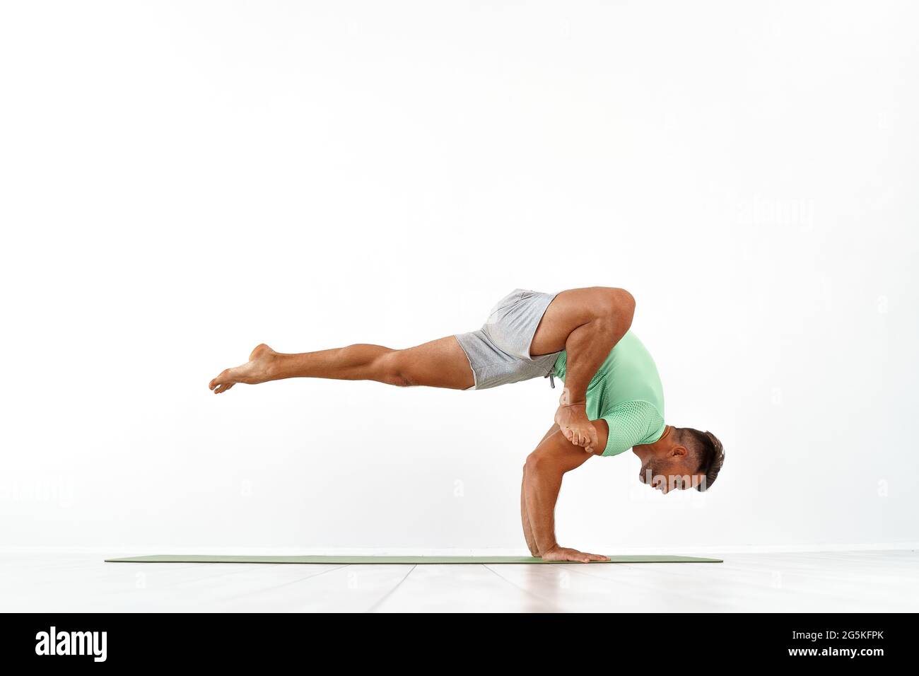 Man practicing balance yoga pose Stock Photo - Alamy