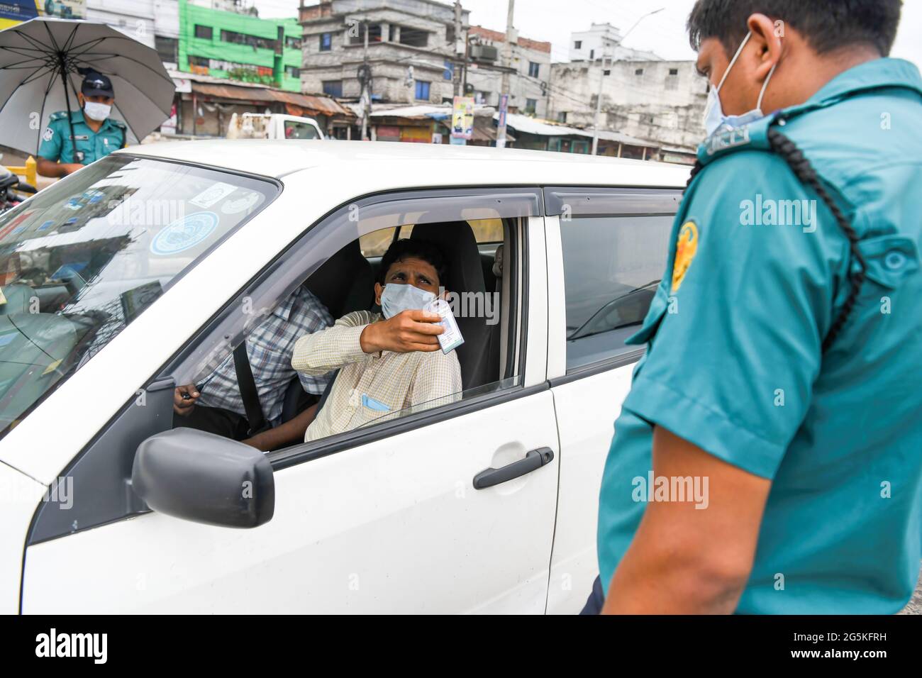Police officer inspects the vehicle at a checkpoint at the Gabtoli area in Dhaka. (Photo by ...