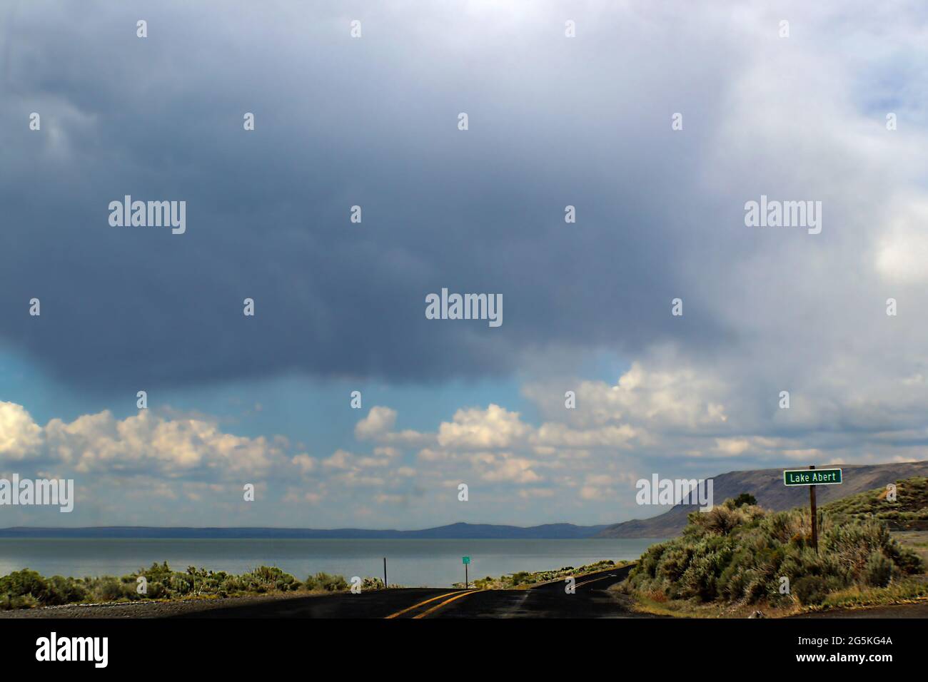 Road trip - Blacktop two lane highway curves along Lake Abert in Oregon ...