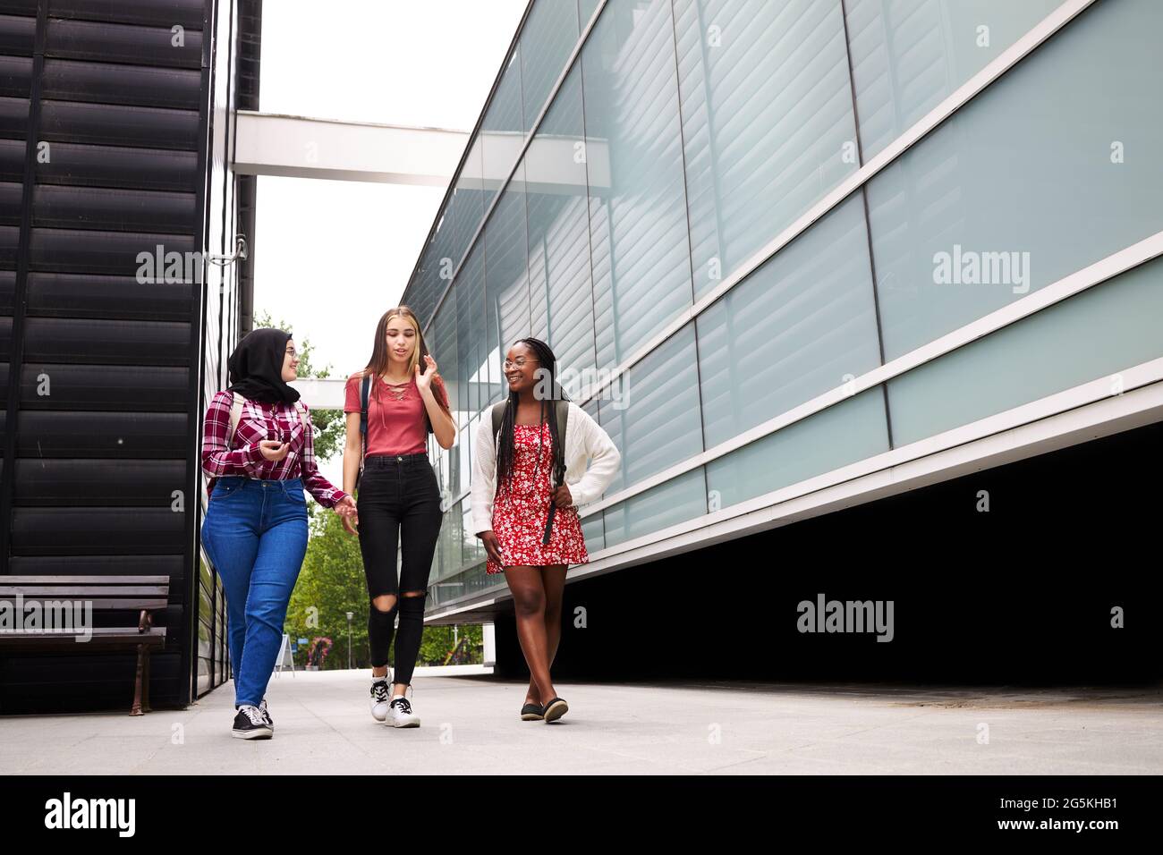 Young students talking and hanging out around university campus Stock ...