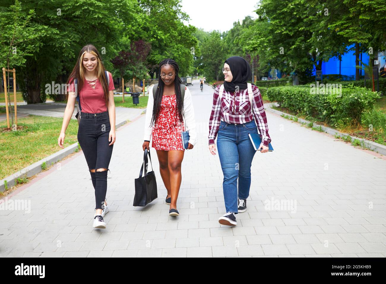 Three friends exploring their university campus Stock Photo - Alamy