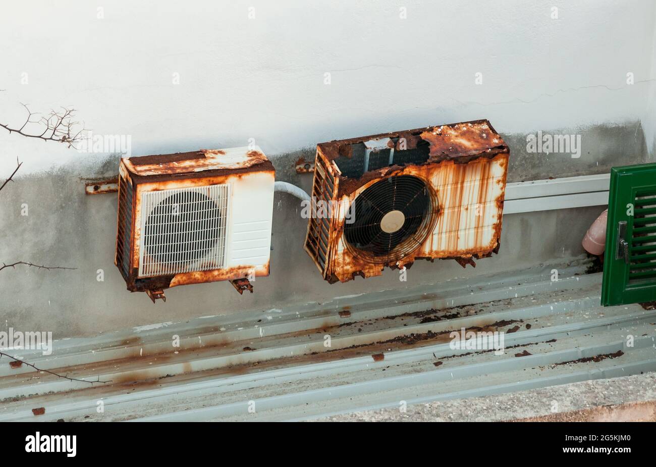Two old rusted air conditioners on the white wall on the house Stock ...