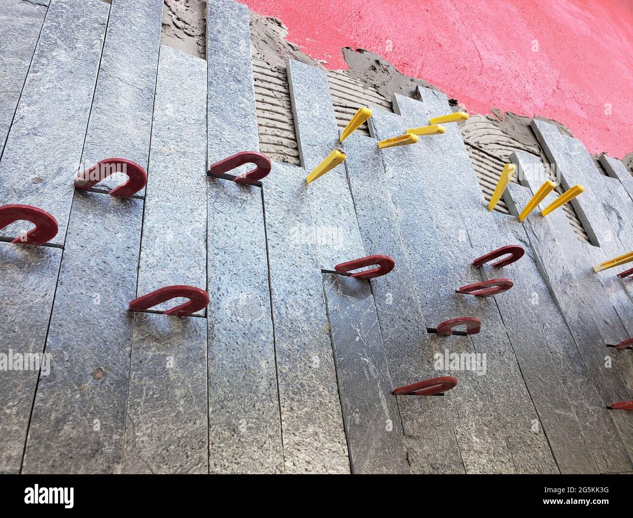 Colorful Shims for tile installation in the wall Stock Photo - Alamy