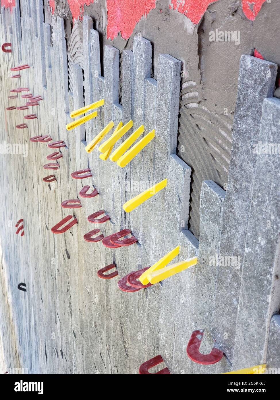 Colorful Shims for tile installation in the wall Stock Photo - Alamy