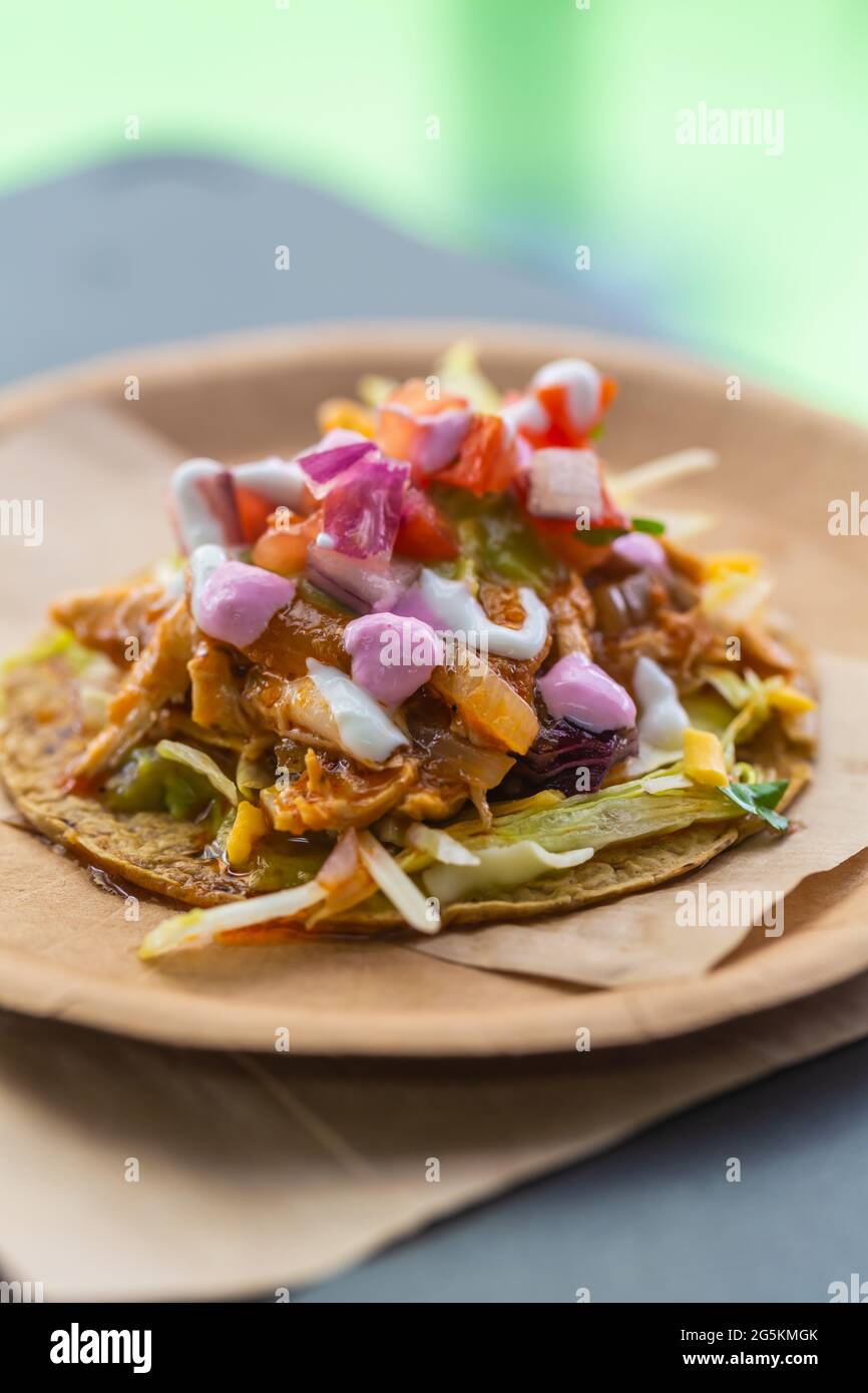 Salsa tacos on a paper plate in a street cafe. Traditional Mexican dish ...