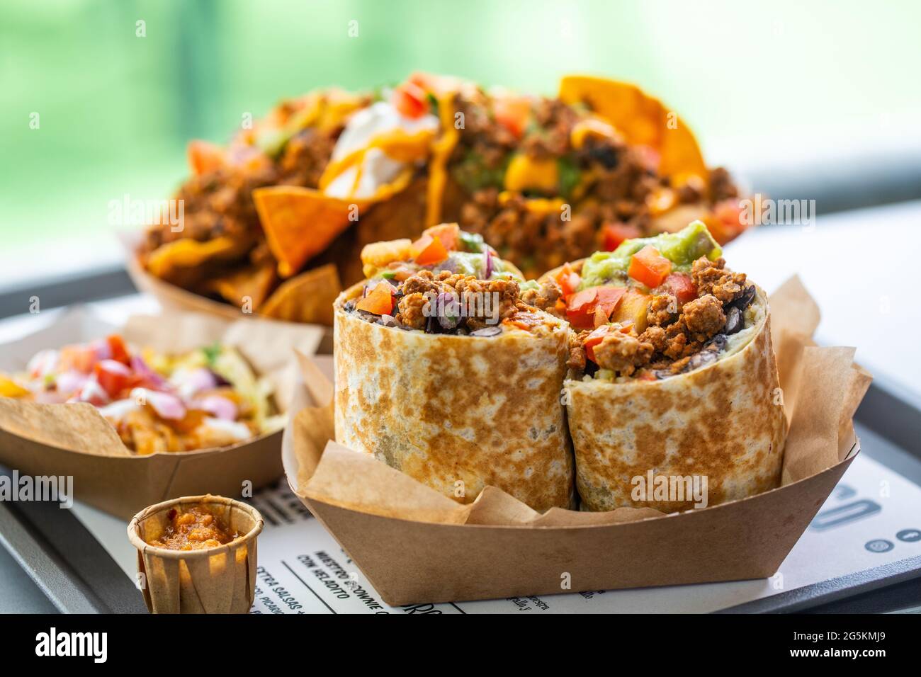 Mexican traditional food in a fast food cafe. salsa nachos and burrito ...