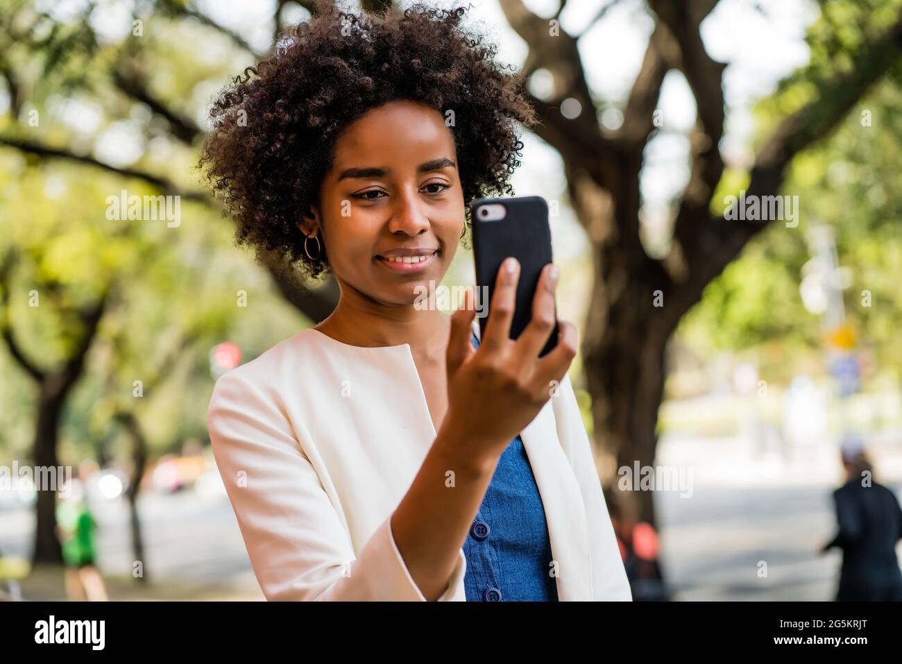 Afro business woman having a video call on mobile phone Stock Photo - Alamy