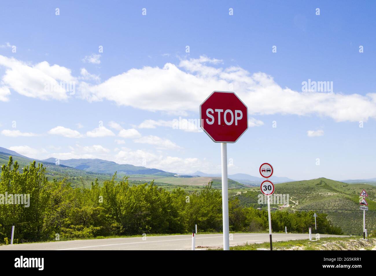 Red stop sign on the highway in Didgori, Georgia Stock Photo - Alamy