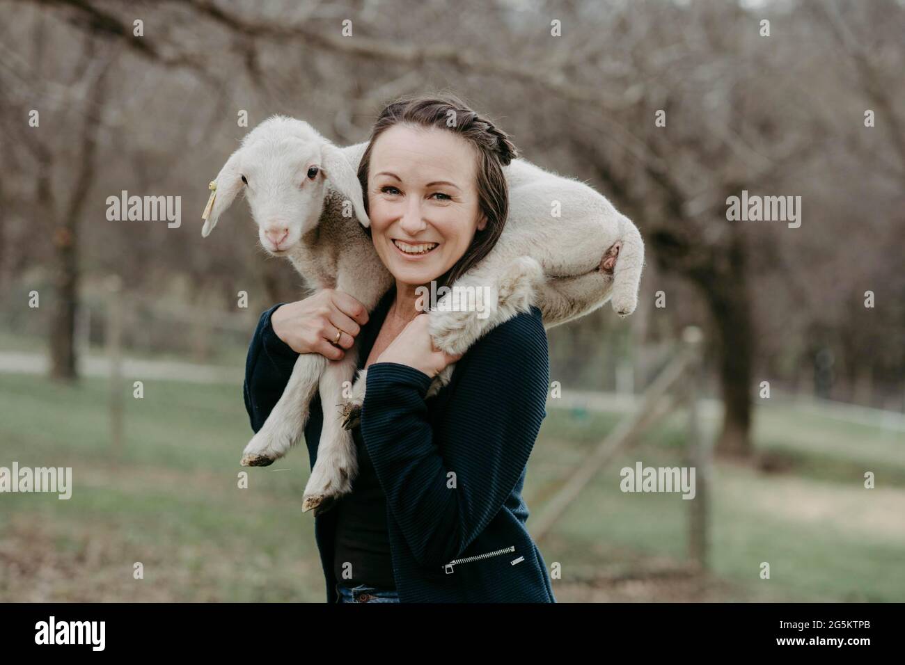 Woman with lamb on her shoulders, Austria, Europe Stock Photo - Alamy