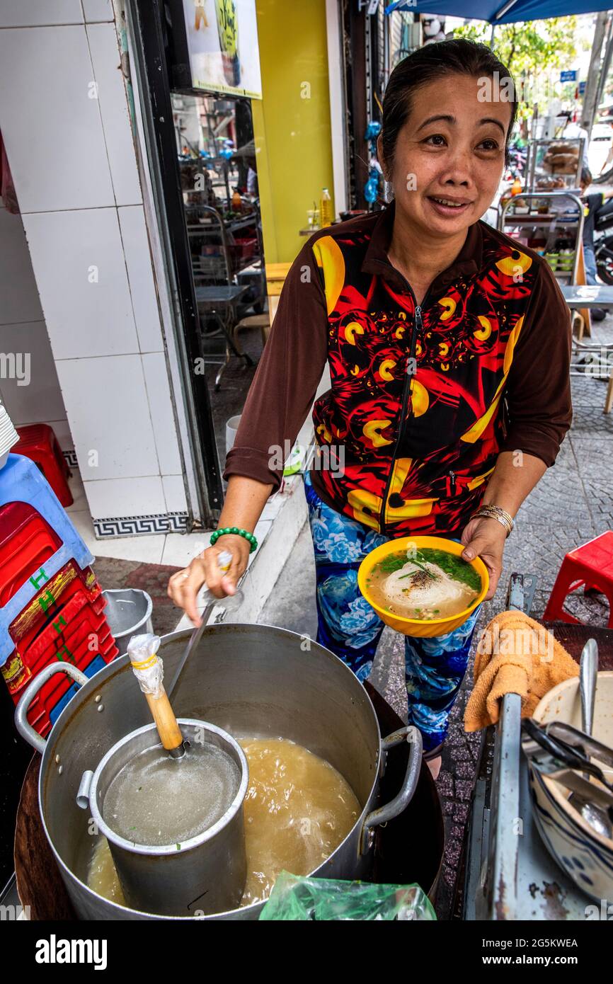 Street Food Cook Adds Ingredients To A Fresh Bowl of Rice Noodles Stock ...