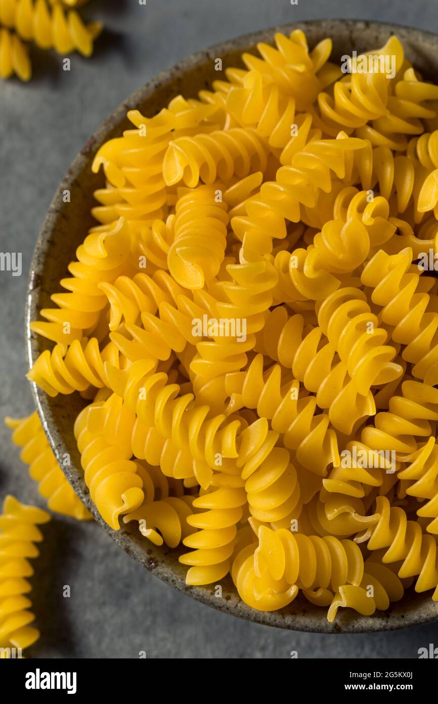 Dry Yellow Organic Rotini Pasta in a Bowl Stock Photo - Alamy