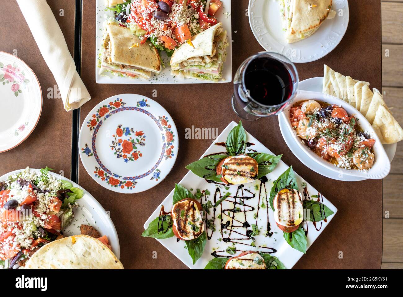 Overhead view of table filled with plates of food in a restaurant Stock ...