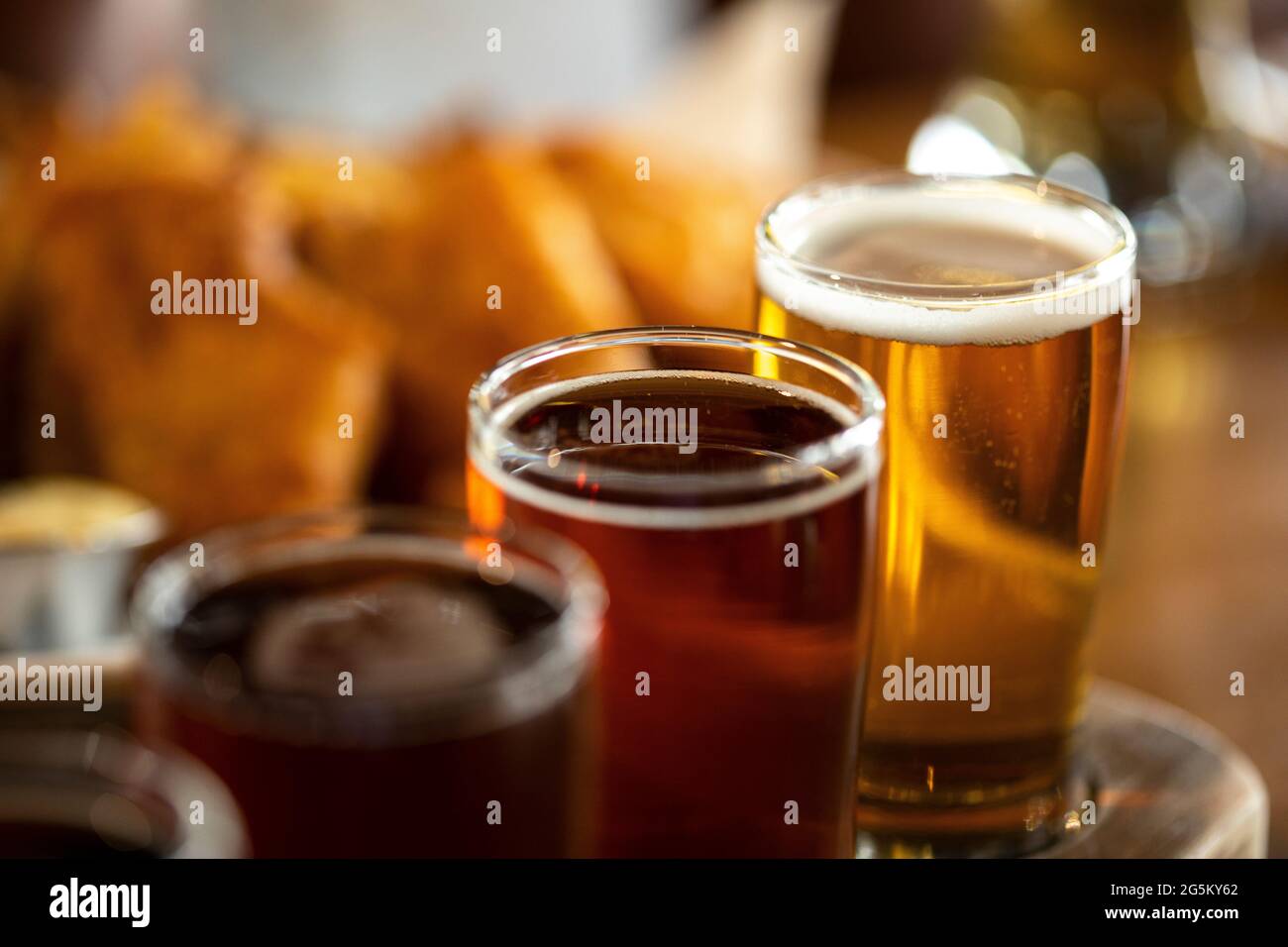 Close up view of amber colored beers in warm light soft background ...