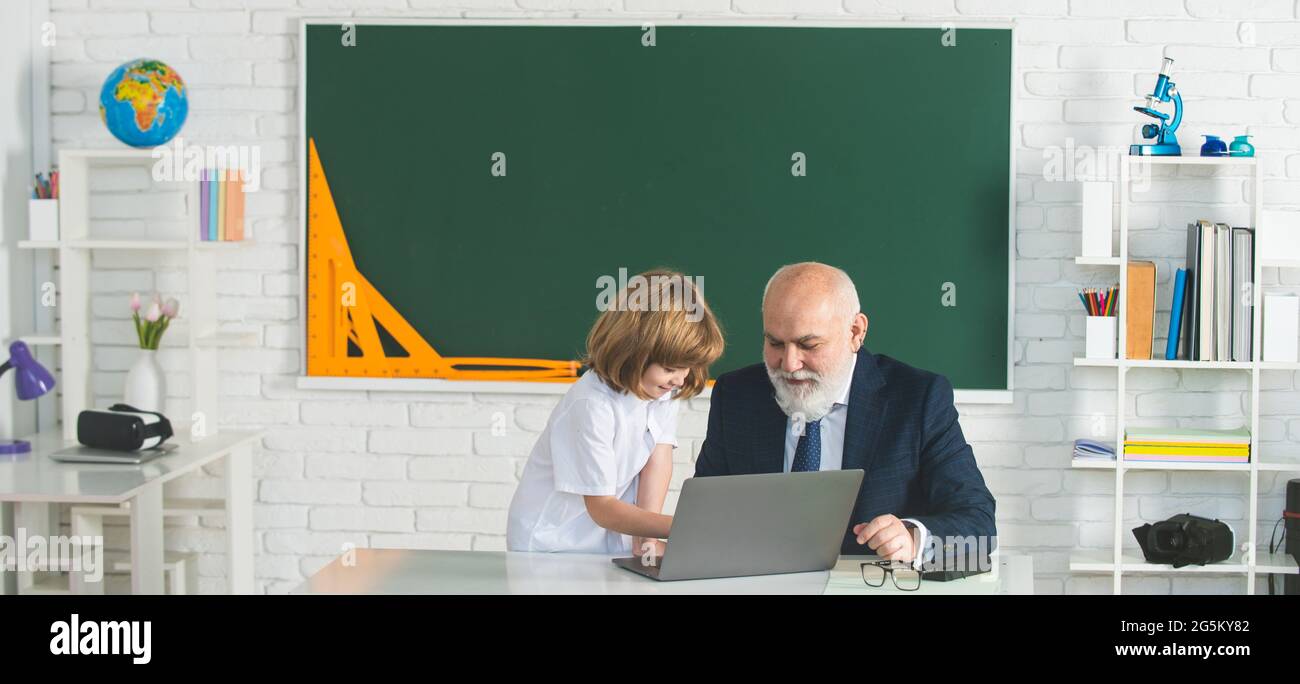 Teacher and child in classroom. Education concept. School learning ...